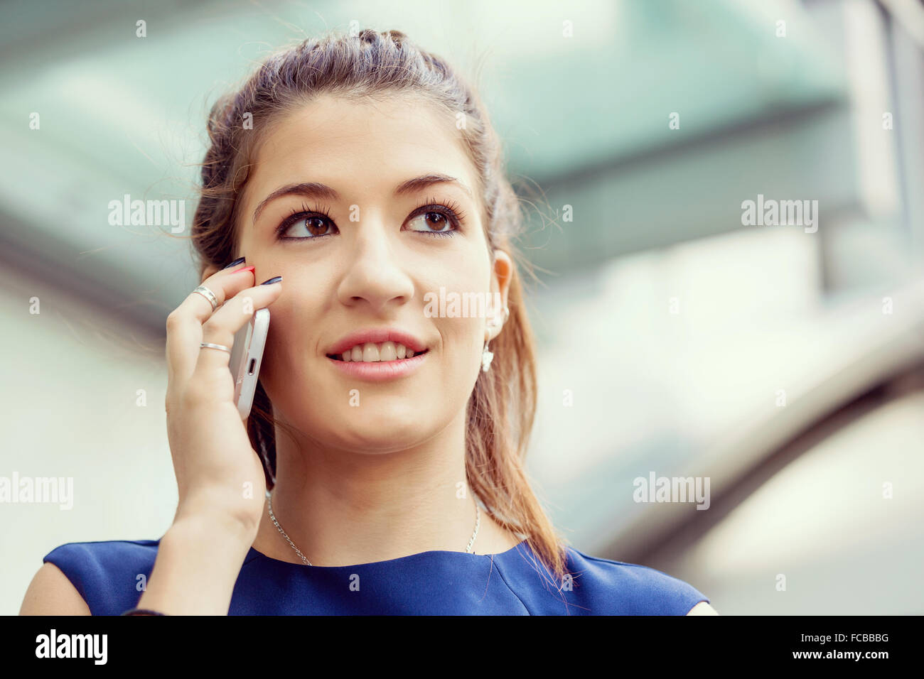 Business woman in a street using her smart phone Stock Photo - Alamy