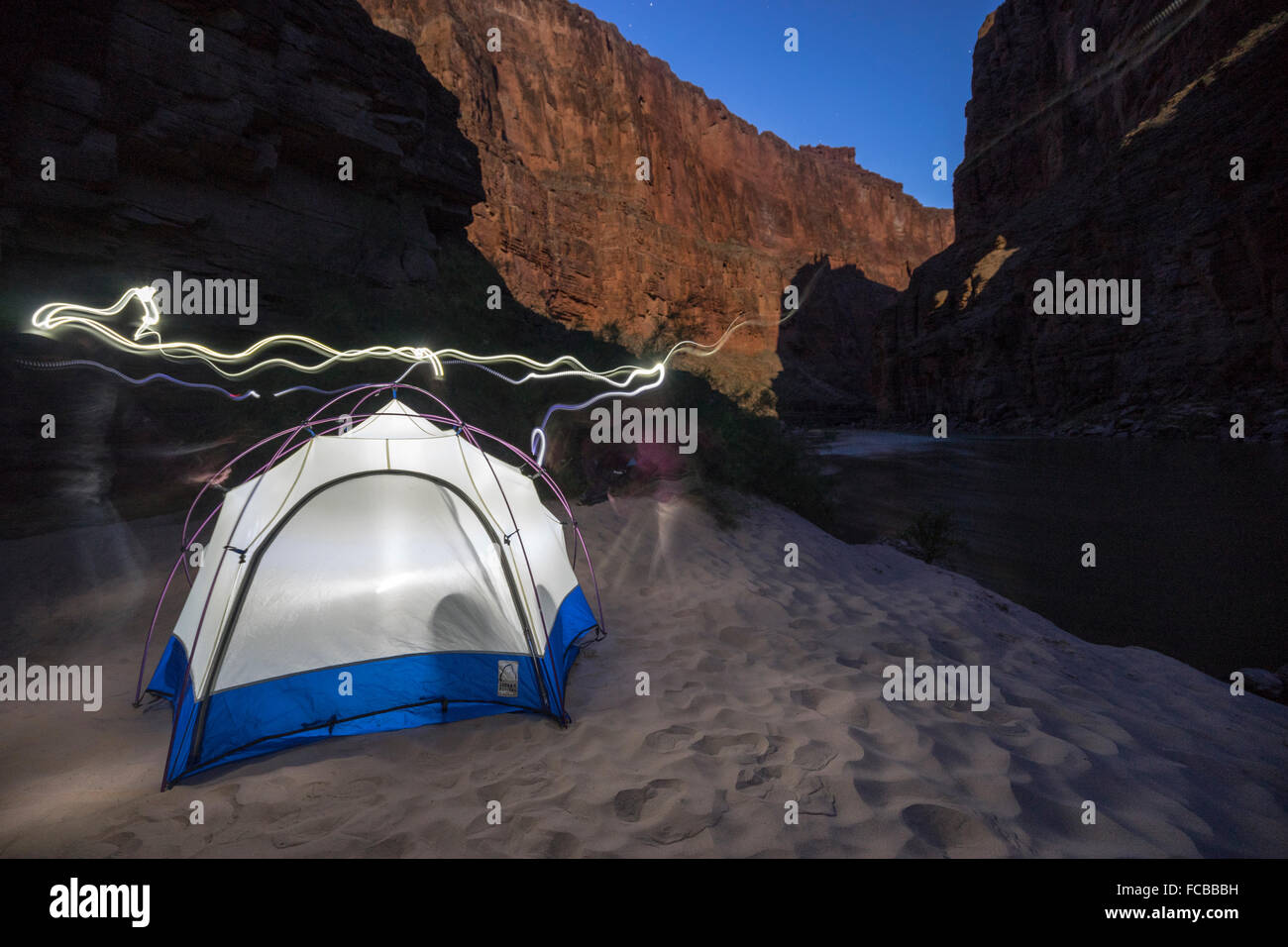 Tent in a canyon with light painting Stock Photo - Alamy
