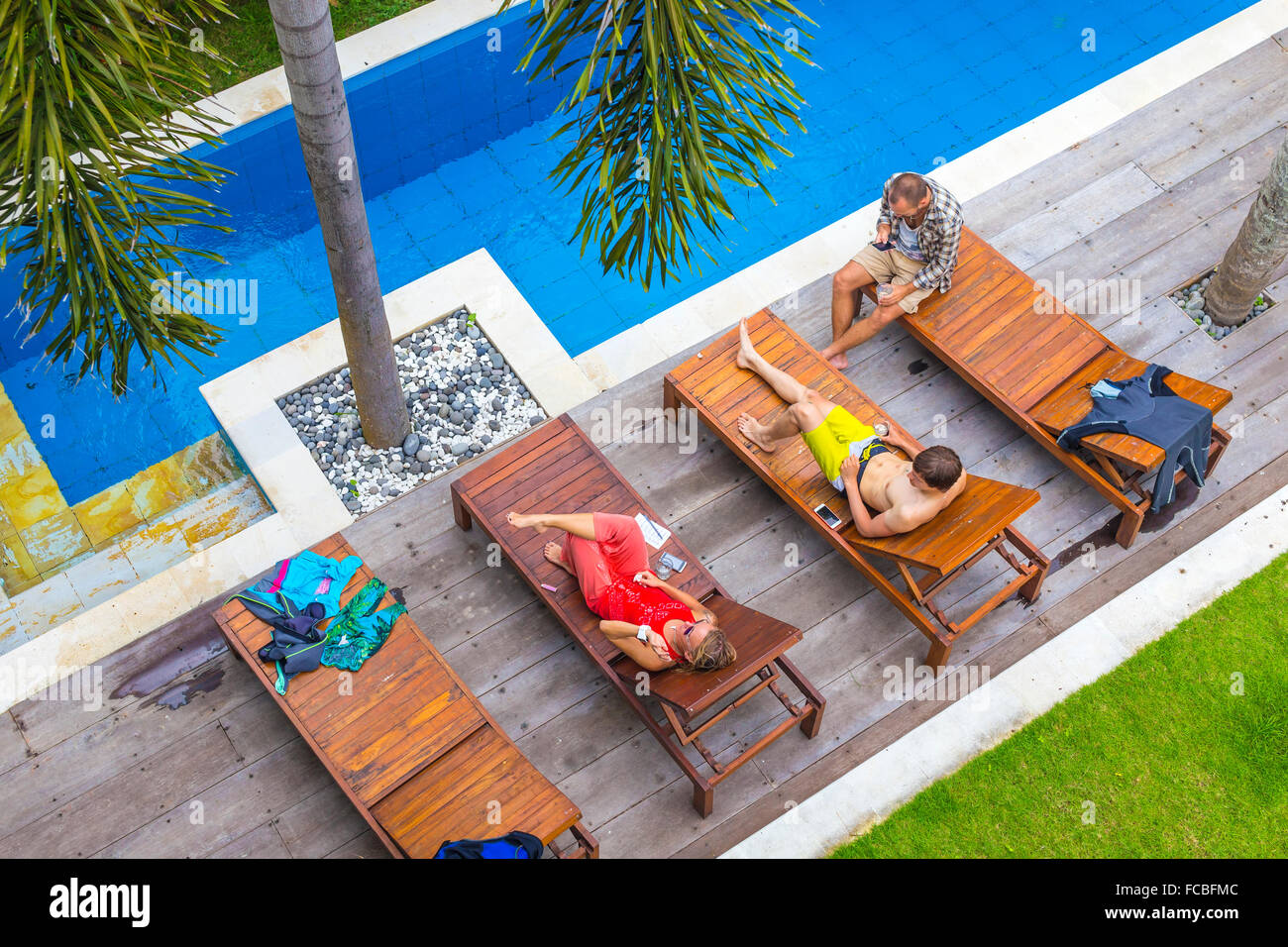 Friends near the tropical pool Stock Photo - Alamy