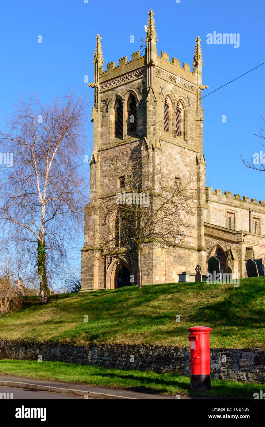St Mary's Parish Church Wymeswold with a traditional red British pillar ...