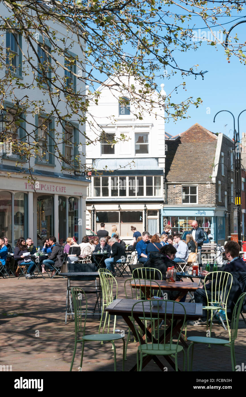 People enjoying the spring sunshine outside cafes in the Market Square ...