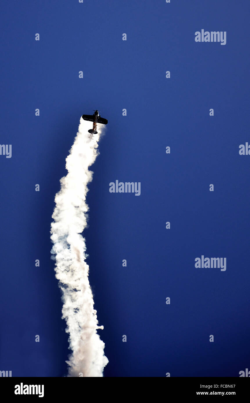 Acrobatic plane doing stunts and dropping smoke Stock Photo - Alamy
