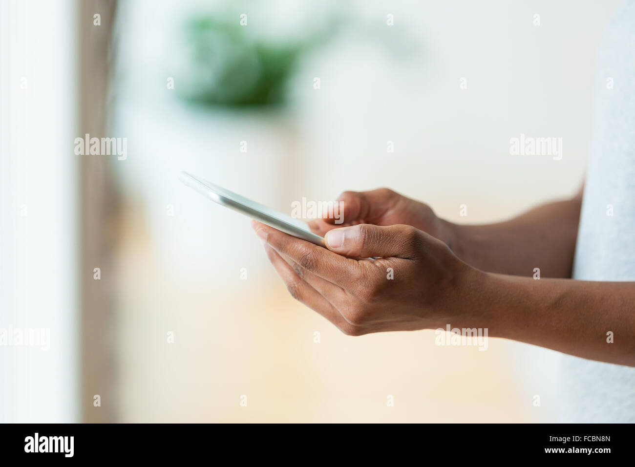 African american person holding a tactile mobile smartphone - Black ...