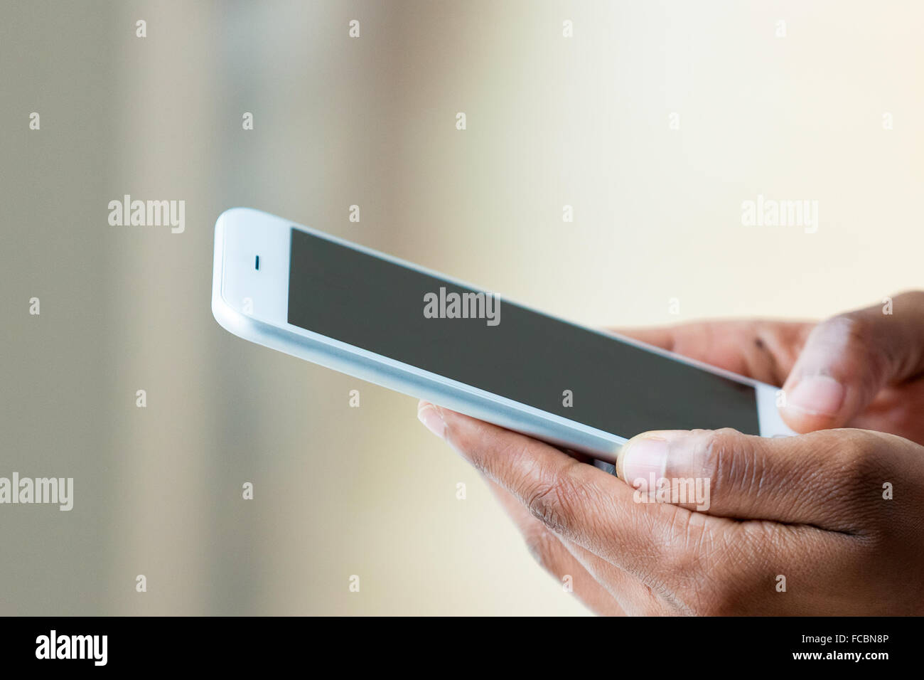 African american person holding a tactile mobile smartphone - Black ...