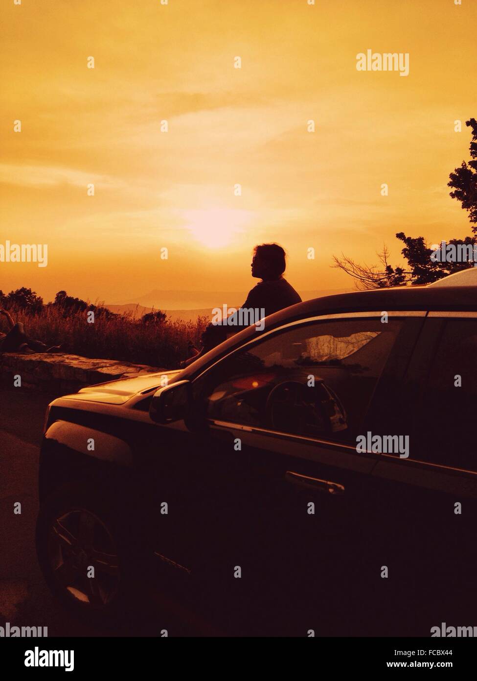 Sitting on car hi-res stock photography and images - Alamy