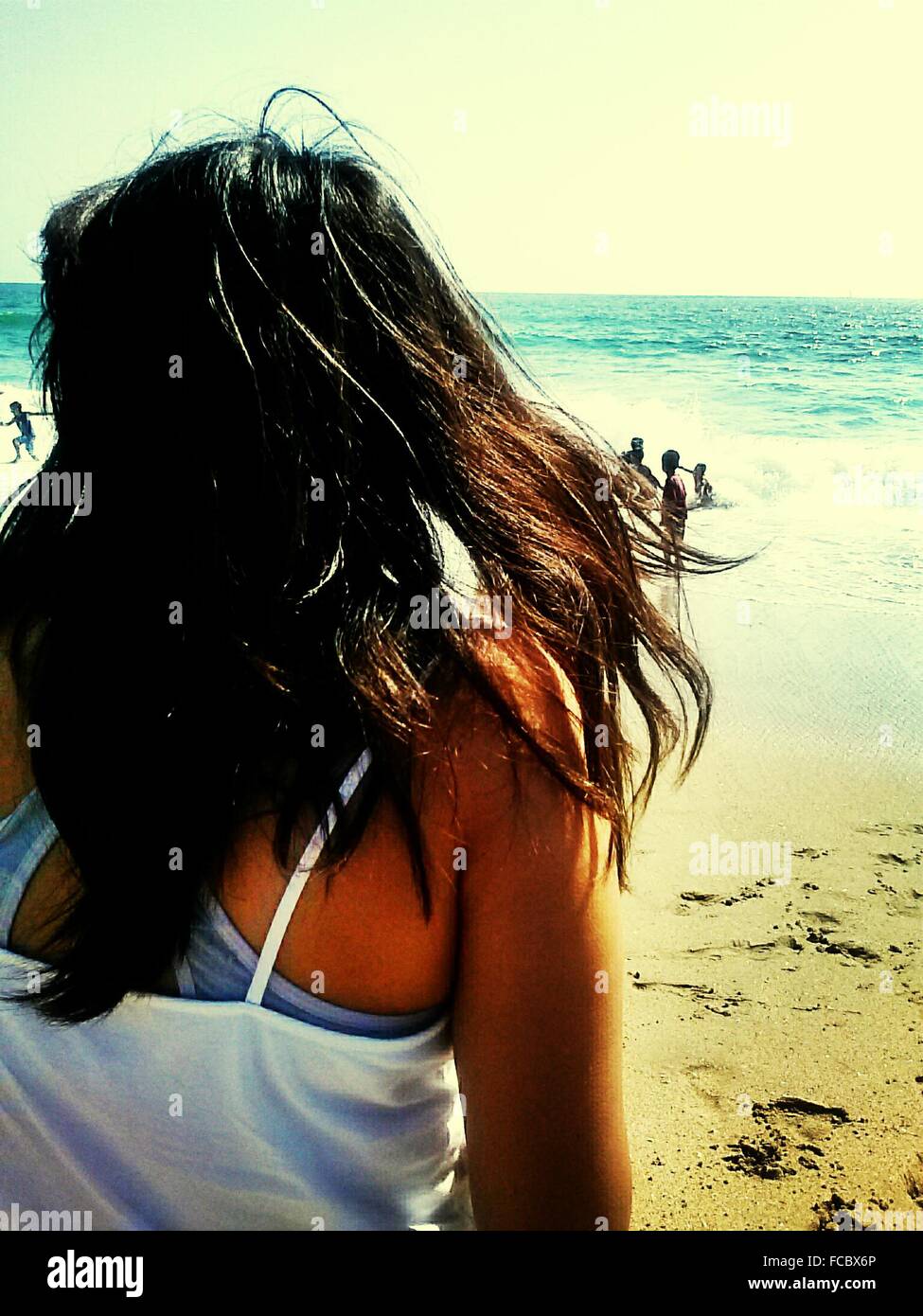 Woman standing at beach hi-res stock photography and images - Alamy