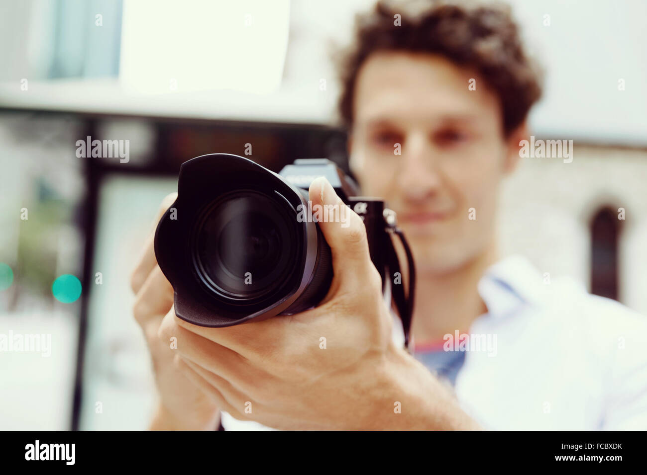 Professional photographer taking picture in city Stock Photo - Alamy