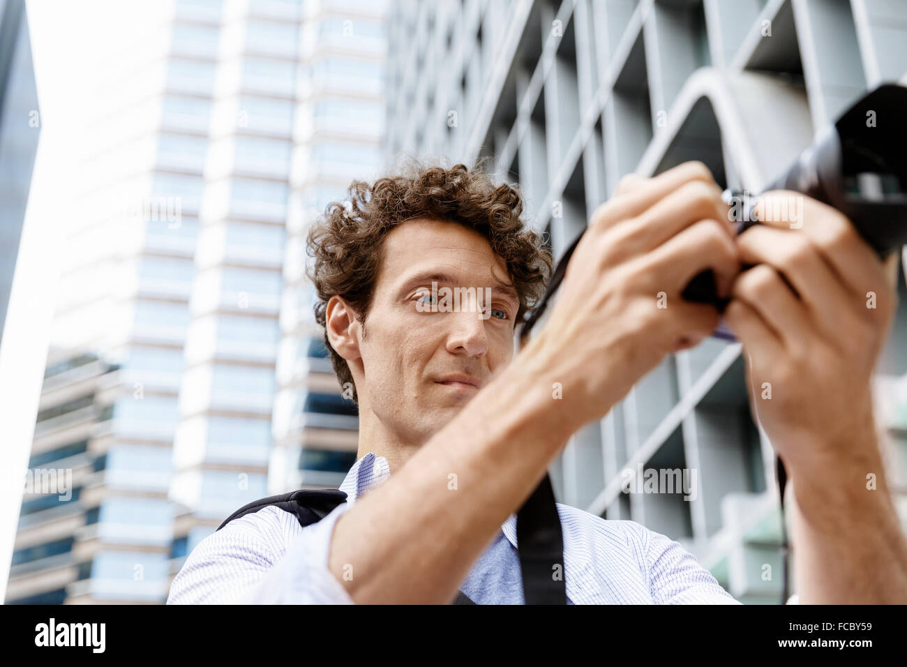 Professional photographer taking picture in city Stock Photo - Alamy