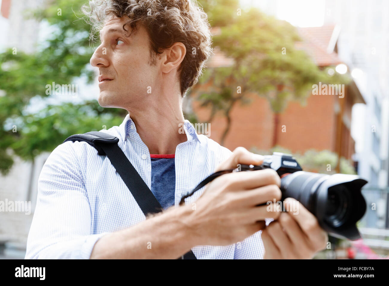 Professional photographer taking picture in city Stock Photo - Alamy
