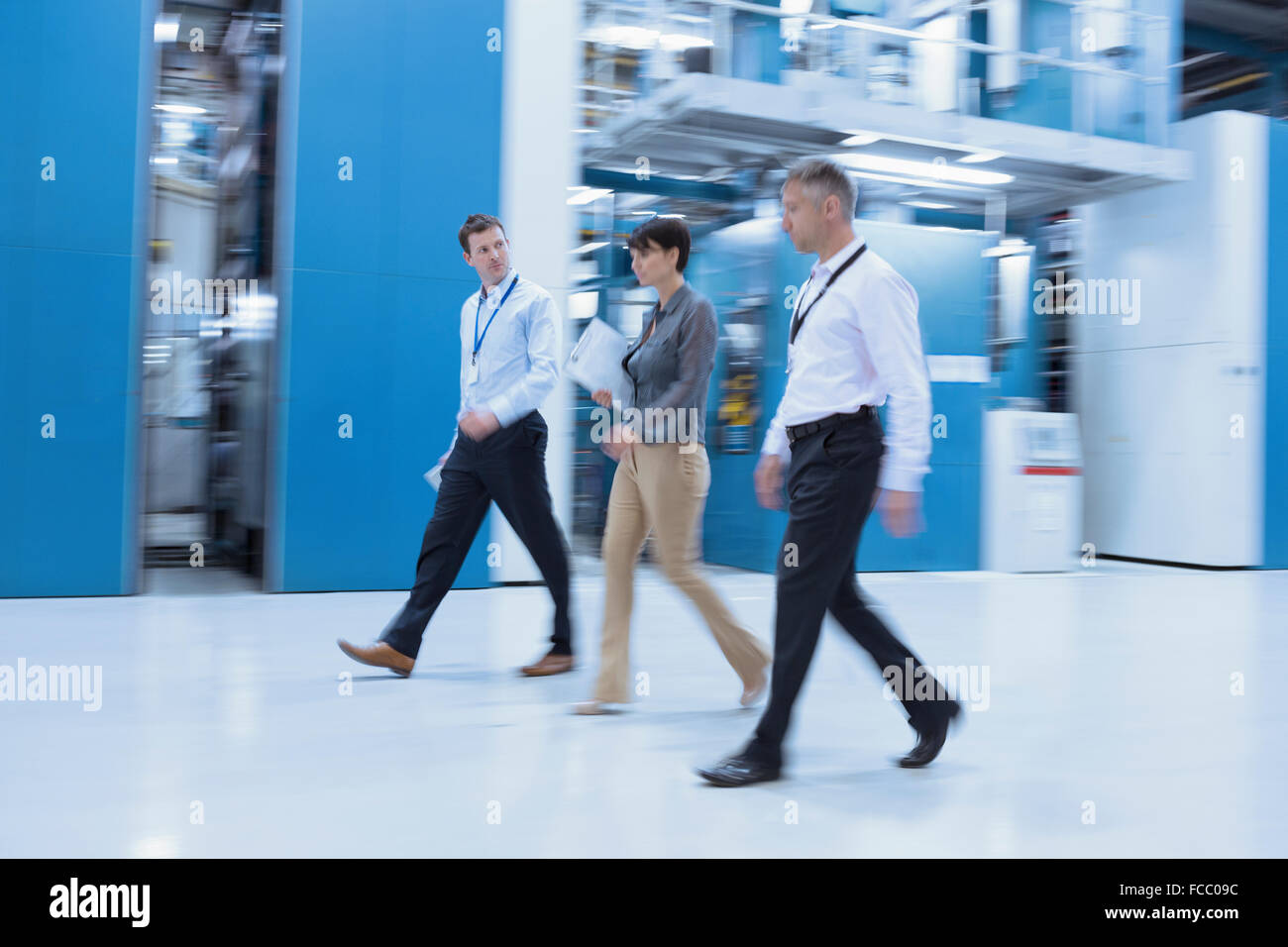 Workers walking in factory Stock Photo - Alamy