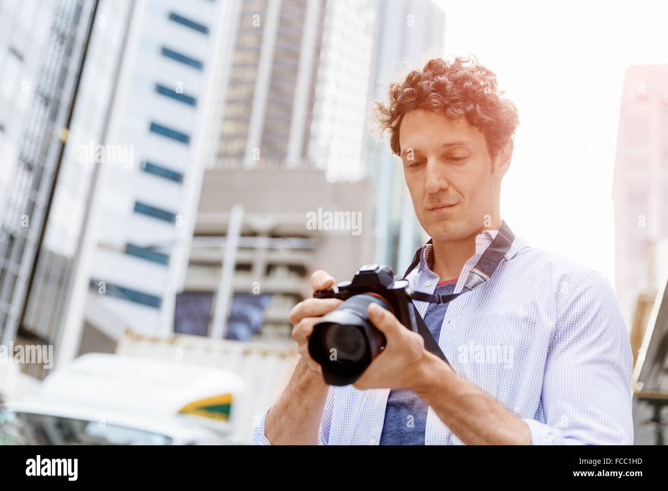 Professional photographer taking picture in city Stock Photo - Alamy