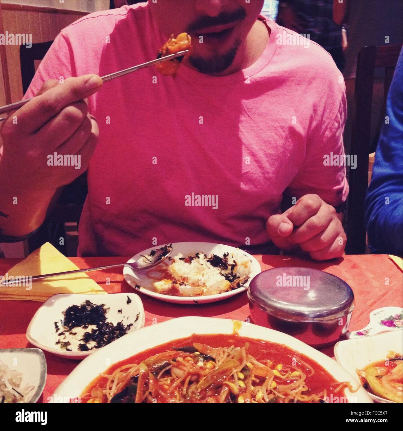 Close-Up Mid Section Of A Man At Dining Table Stock Photo - Alamy