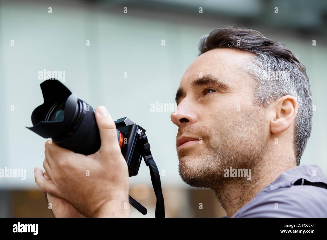 Professional photographer taking picture in city Stock Photo - Alamy