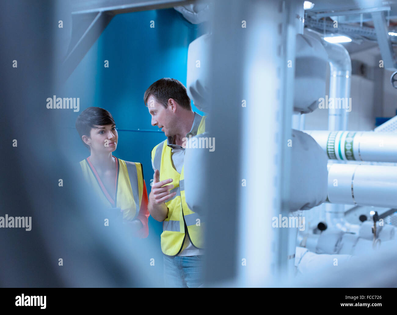 Workers talking in factory Stock Photo - Alamy