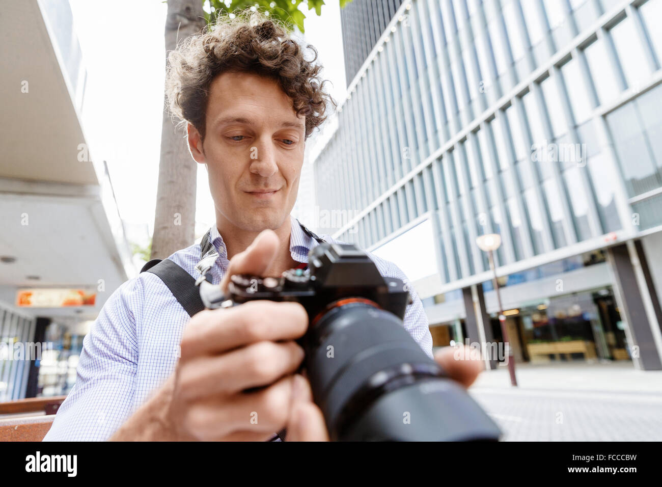 Professional photographer taking picture in city Stock Photo - Alamy