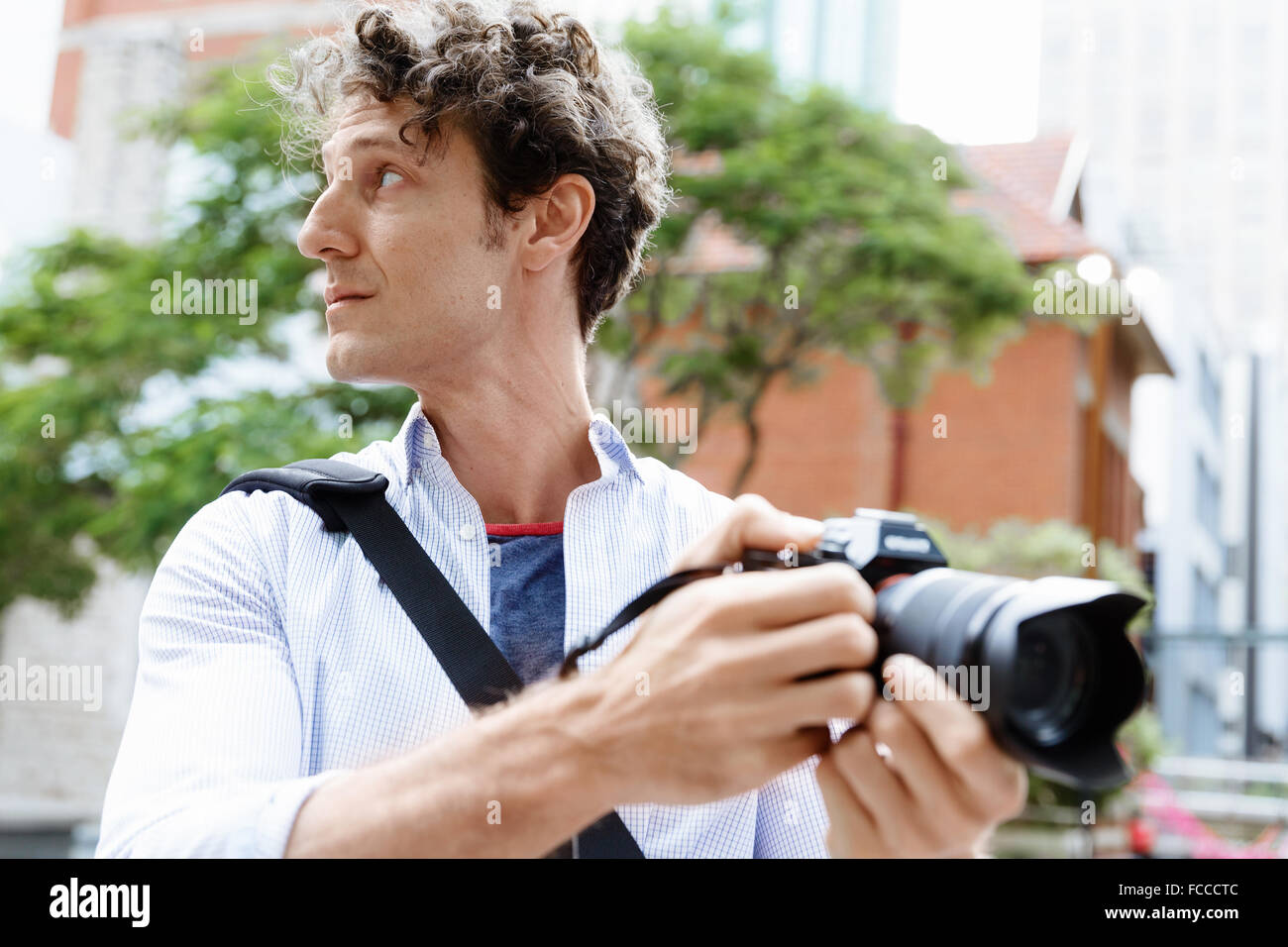Professional photographer taking picture in city Stock Photo - Alamy