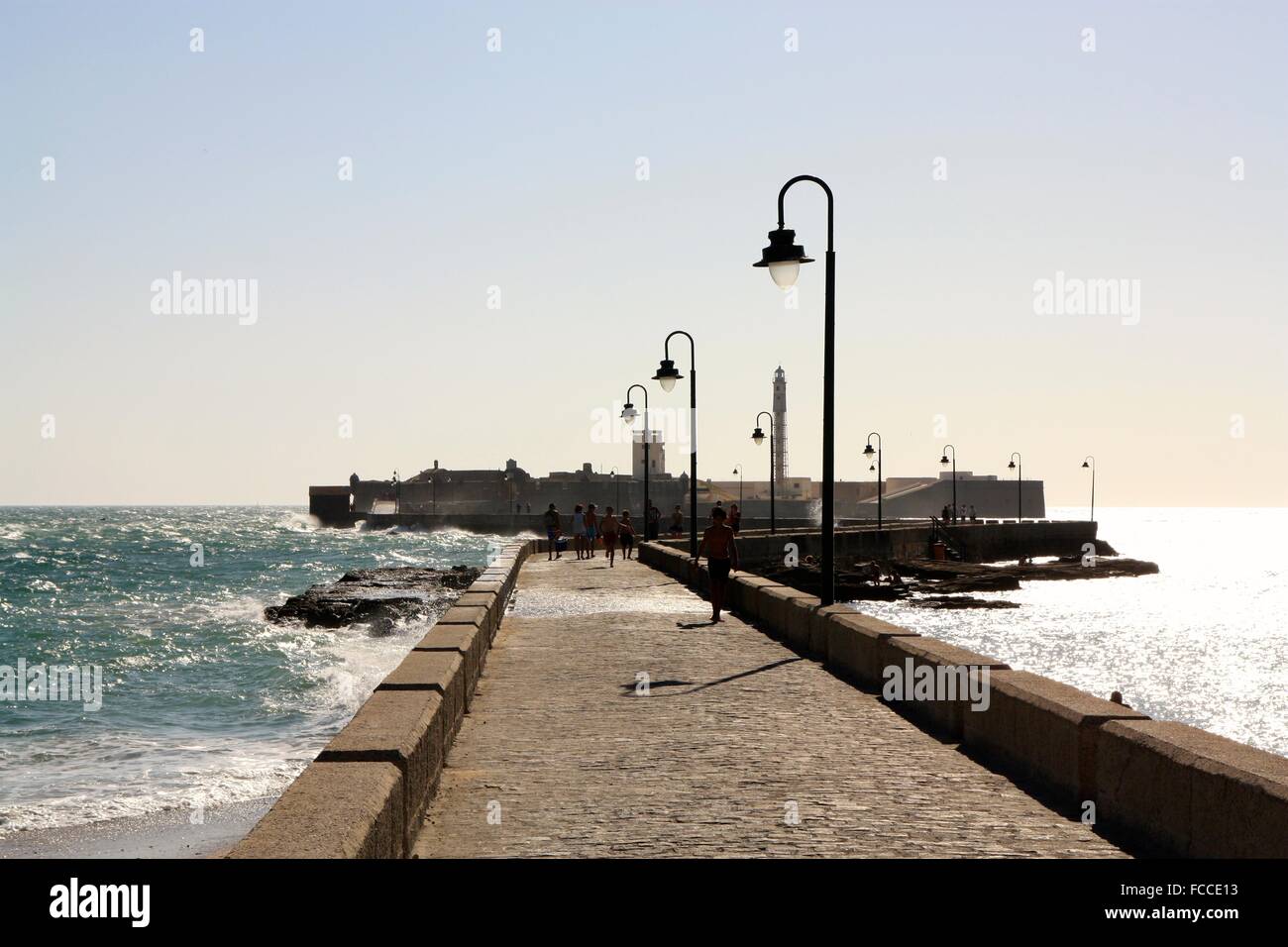 Long Jetty With Lamp Posts Along Calm Sea Stock Photo - Alamy
