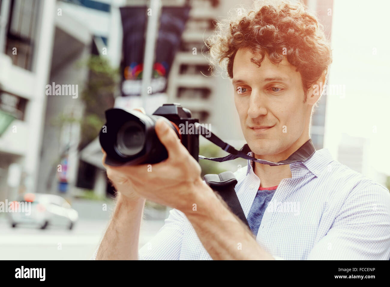 Professional photographer taking picture in city Stock Photo - Alamy