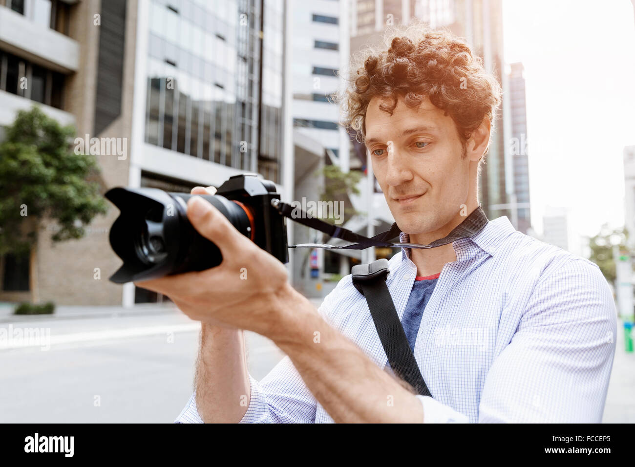 Professional photographer taking picture in city Stock Photo - Alamy