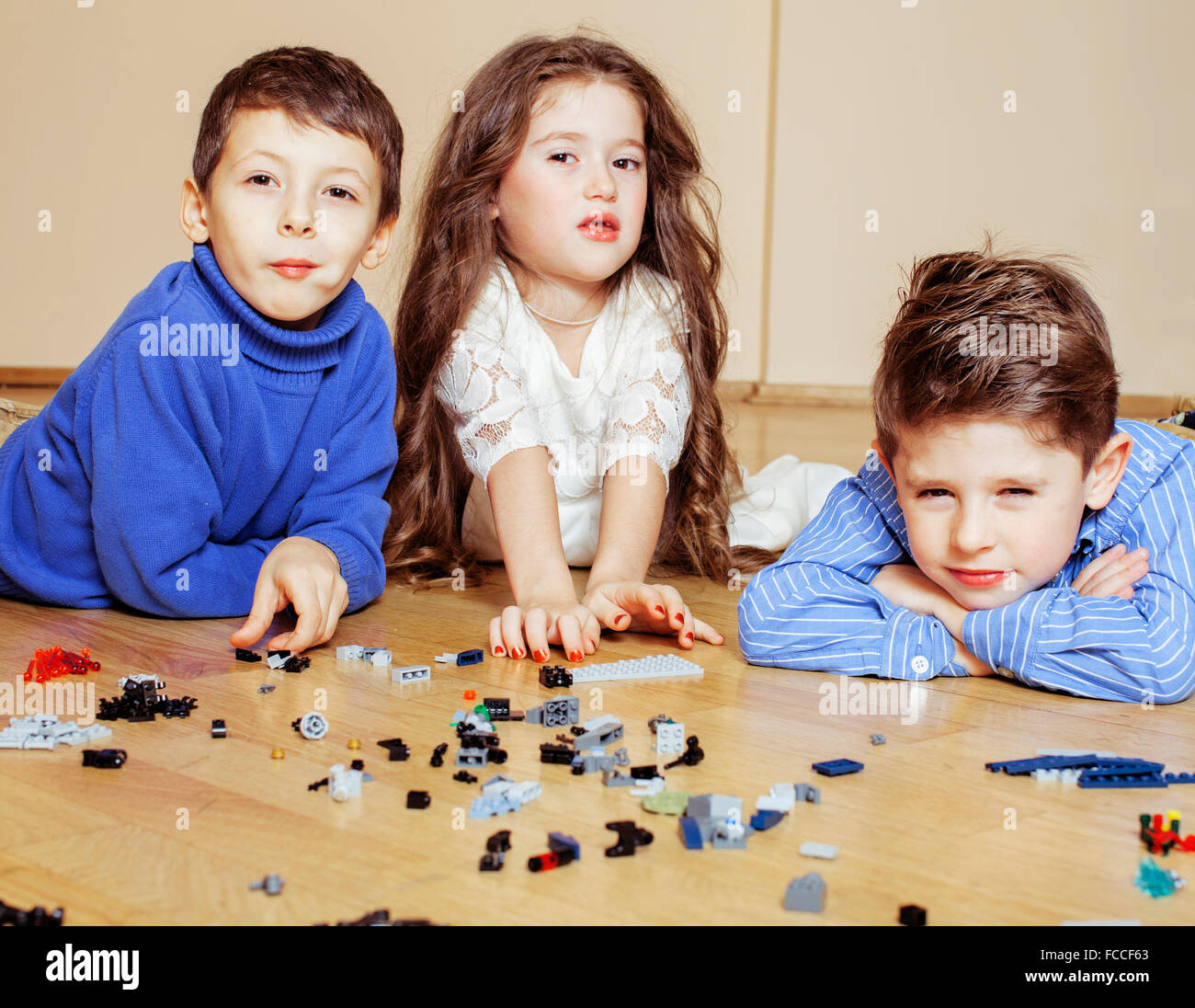 funny cute children playing lego at home, boys and girl smiling, first ...