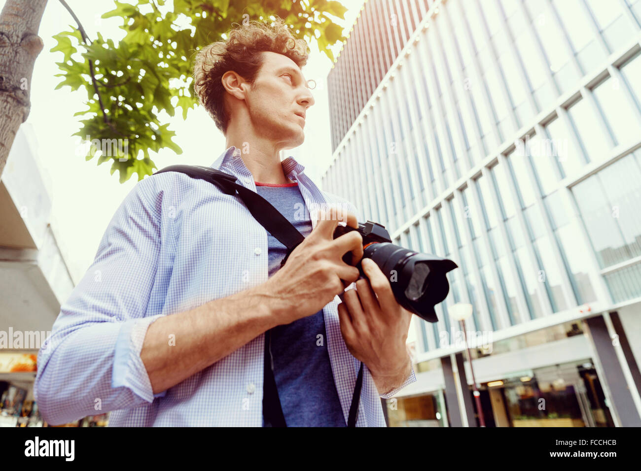 Professional photographer taking picture in city Stock Photo - Alamy