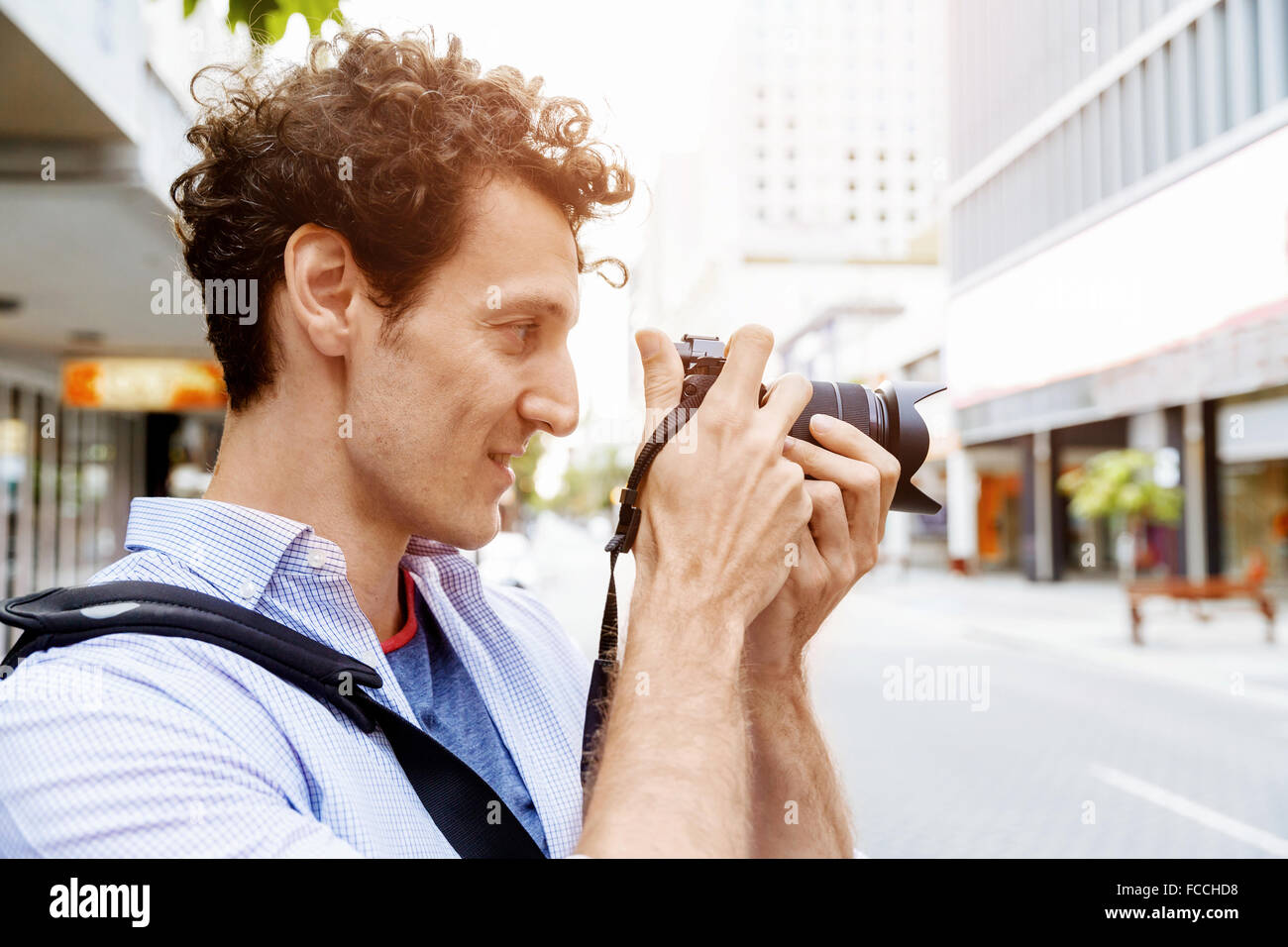 Professional photographer taking picture in city Stock Photo - Alamy