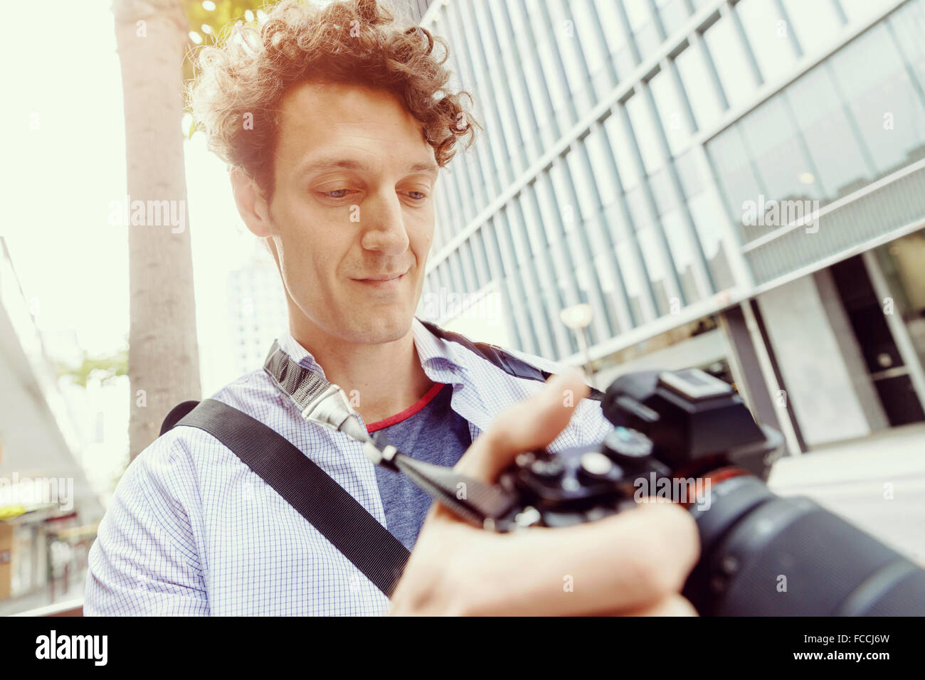 Professional photographer taking picture in city Stock Photo - Alamy