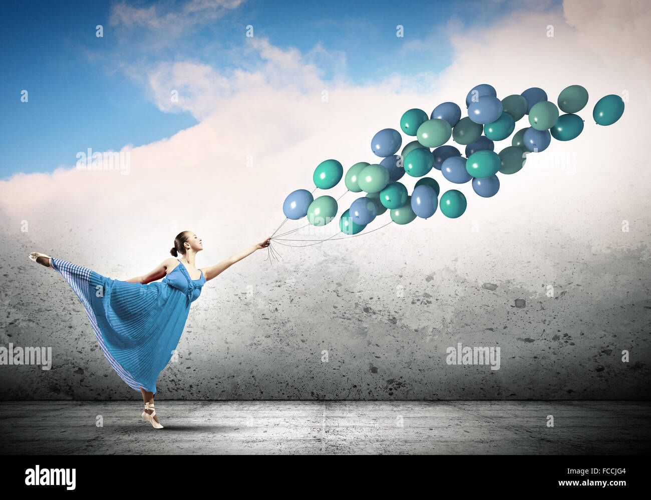 Young woman in dress and ballerinas dancing with colorful balloons ...