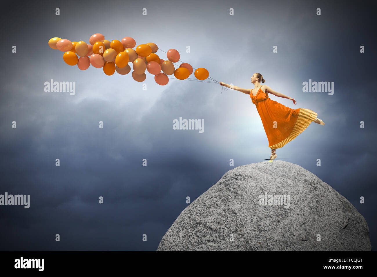 Young woman in dress and ballerinas dancing with colorful balloons ...