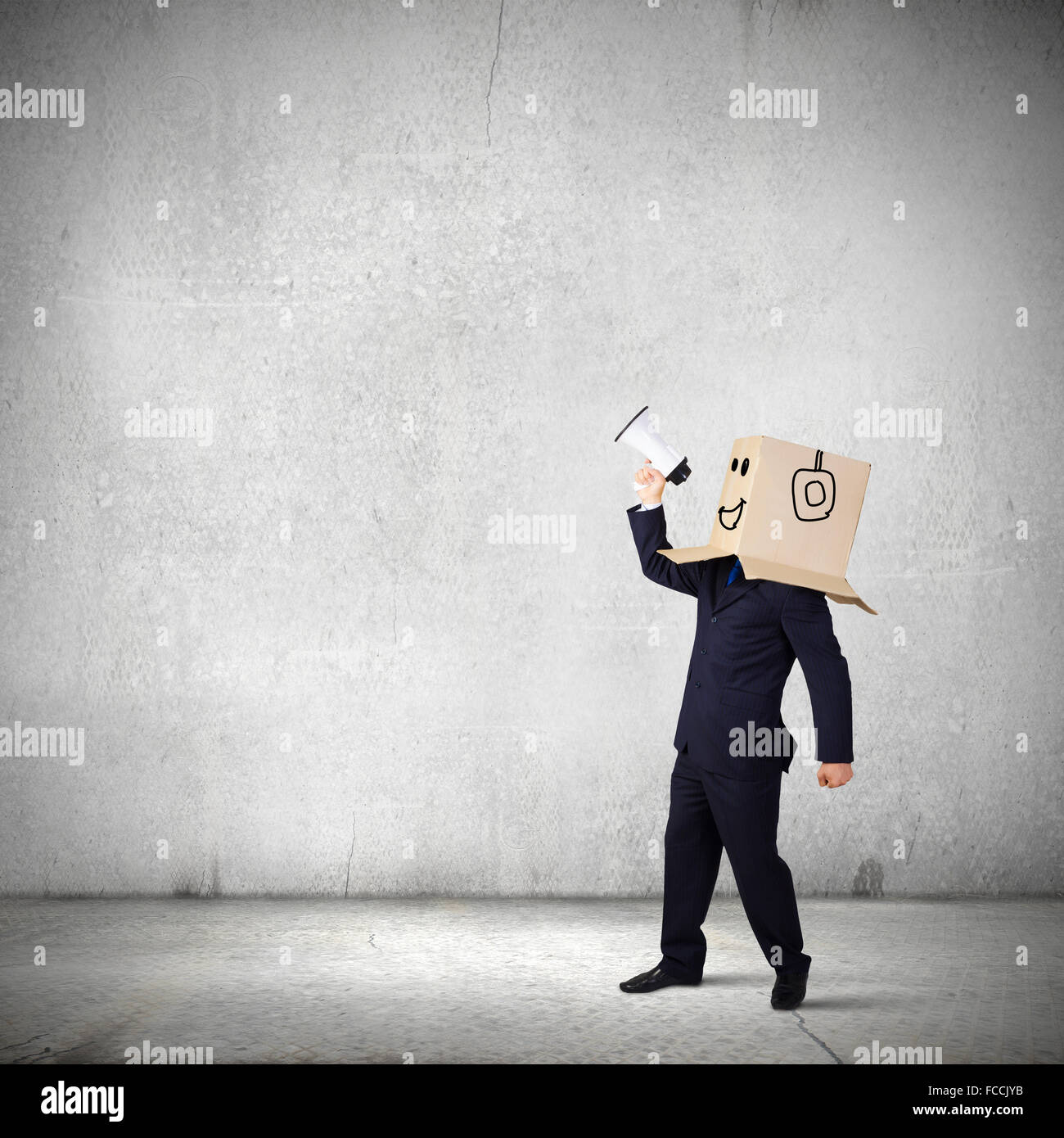 Businessman with box on head screaming in megaphone Stock Photo - Alamy