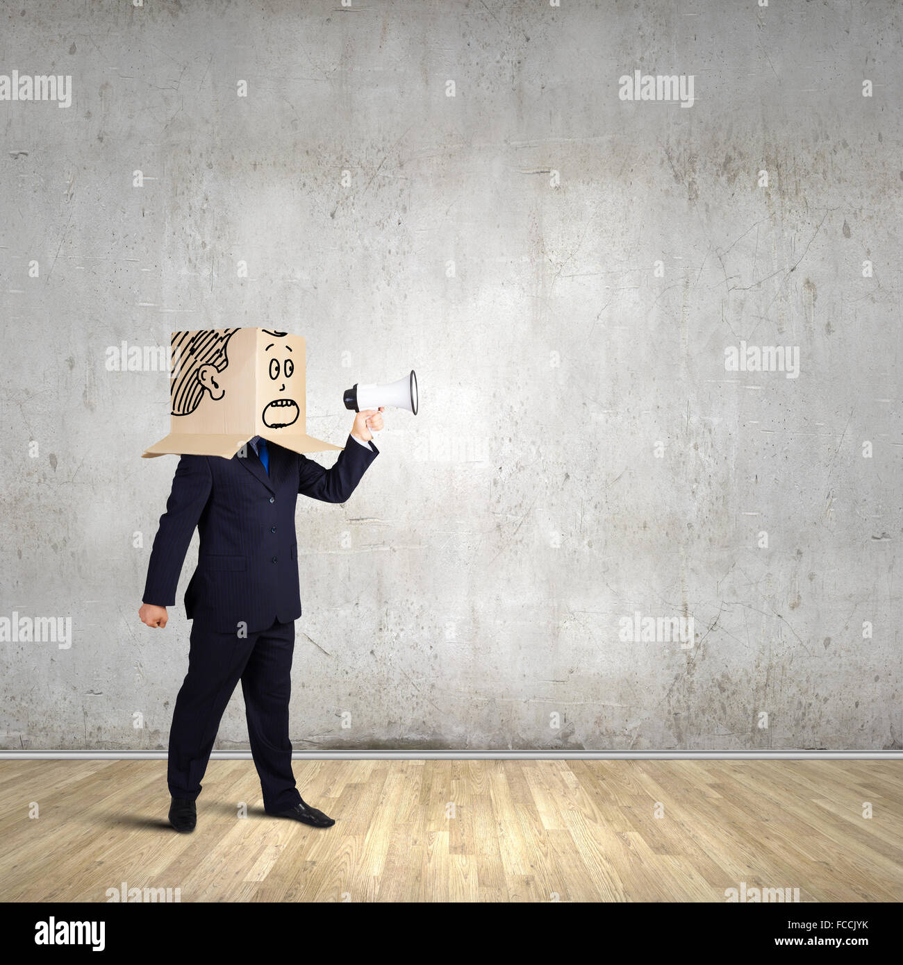 Businessman with box on head screaming in megaphone Stock Photo - Alamy