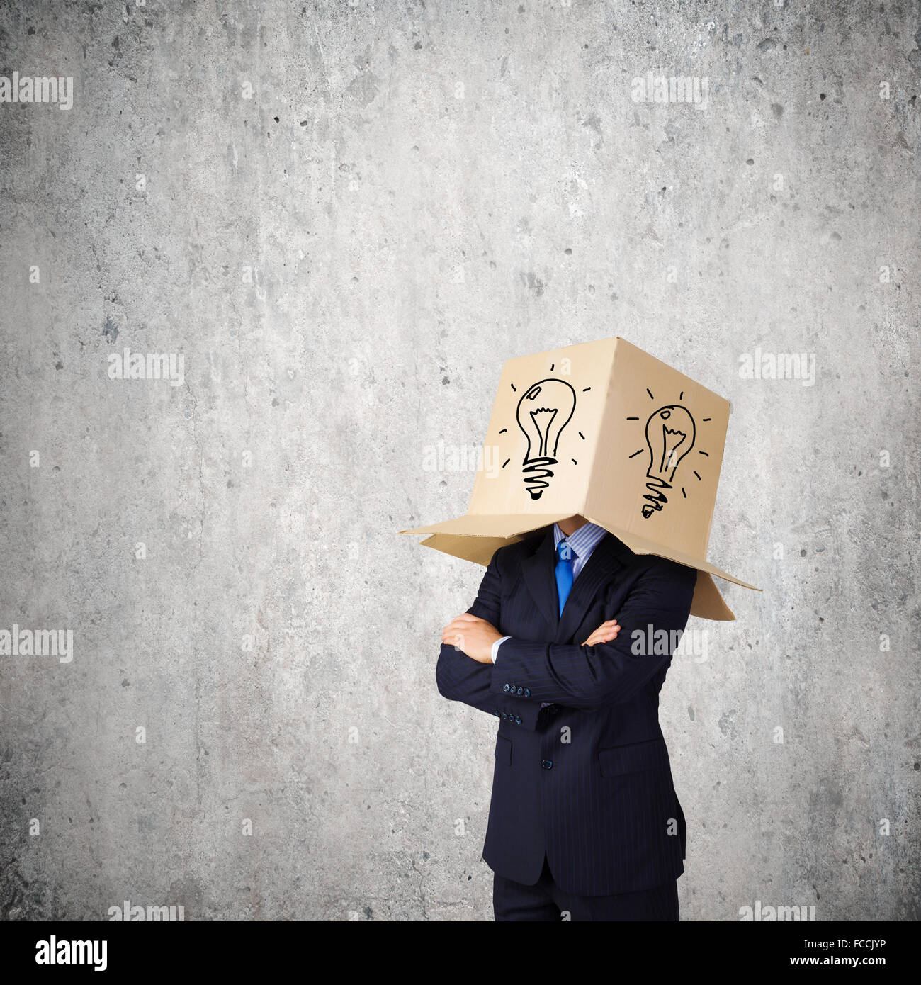 Businessman with box on head and idea symbol Stock Photo - Alamy