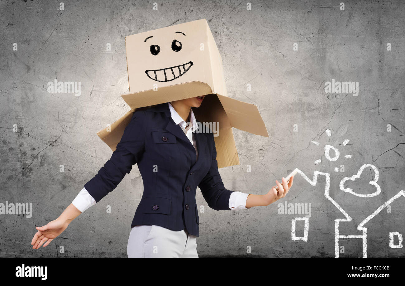 Conceptual image of businesswoman with carton box on head Stock Photo ...