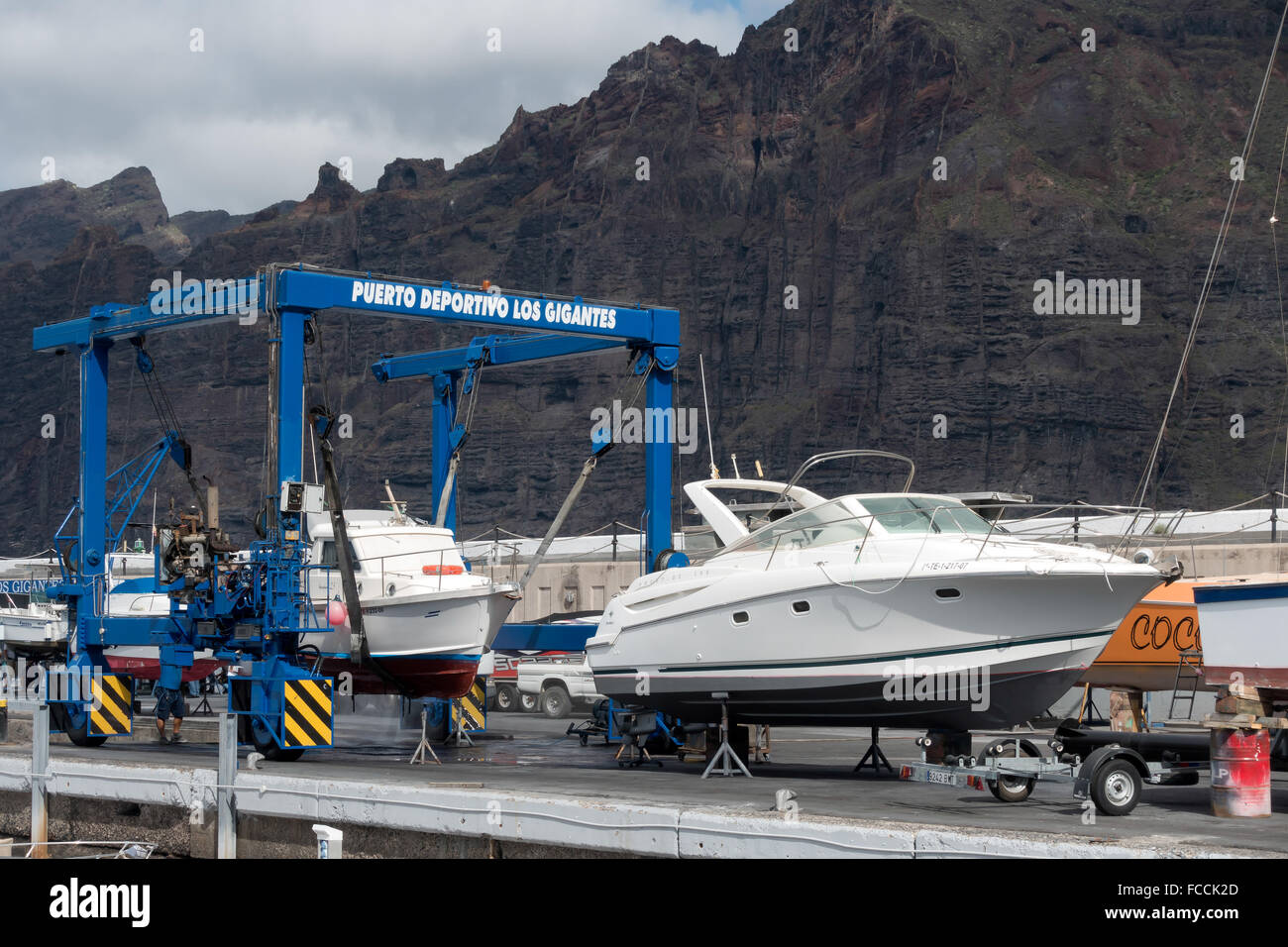 Boat being cleaned in Los Gigantes marina Stock Photo - Alamy