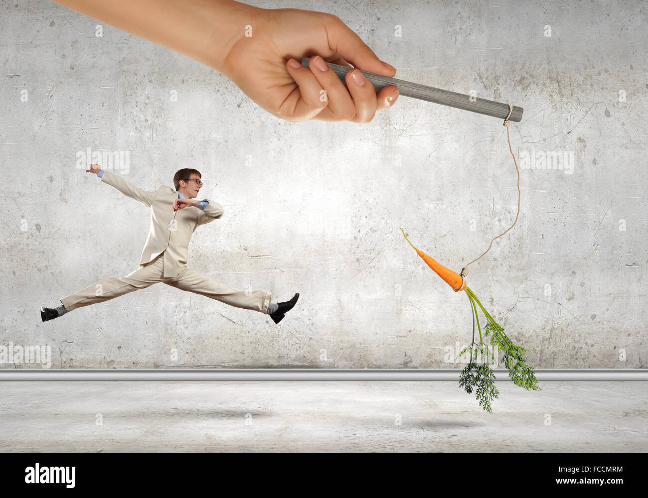 Funny image of businessman chased with carrot Stock Photo - Alamy