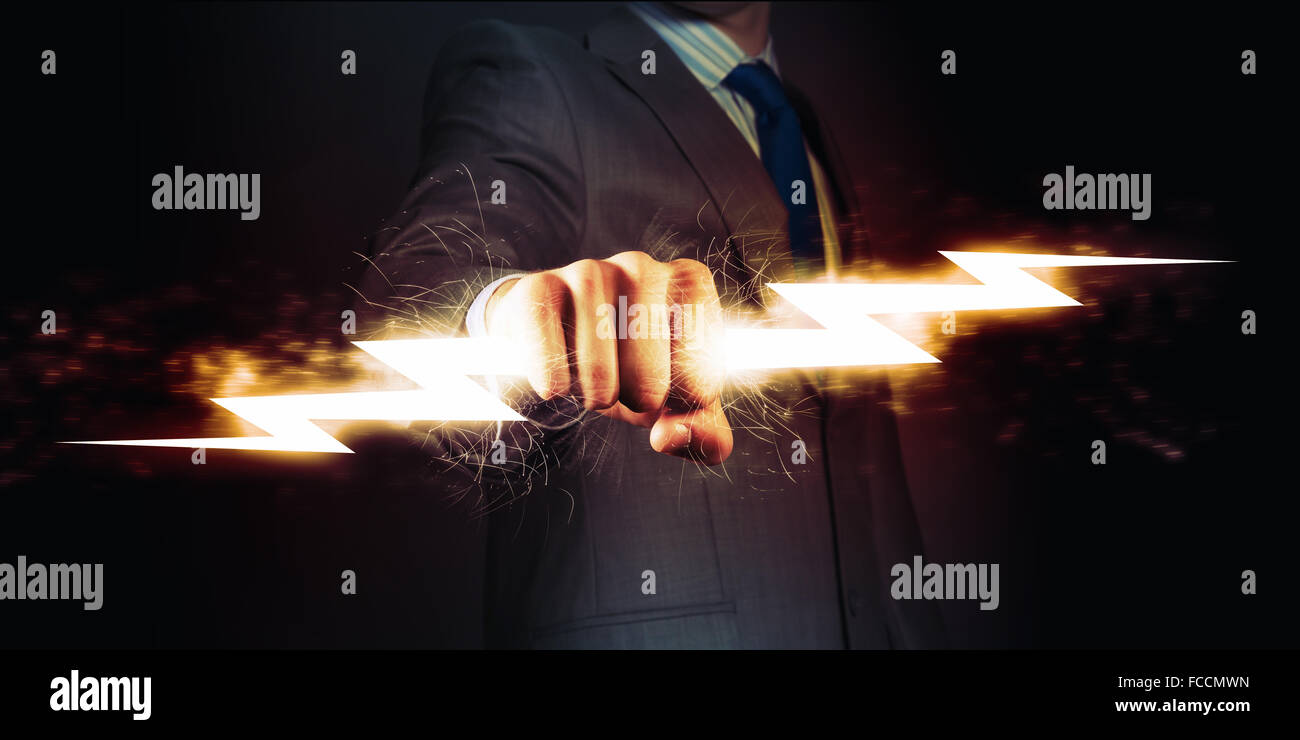 Businessman holding lightning in fist hi-res stock photography and ...