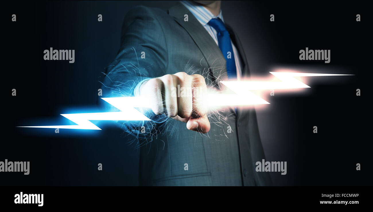 Businessman holding lightning in fist. Power and control Stock Photo ...