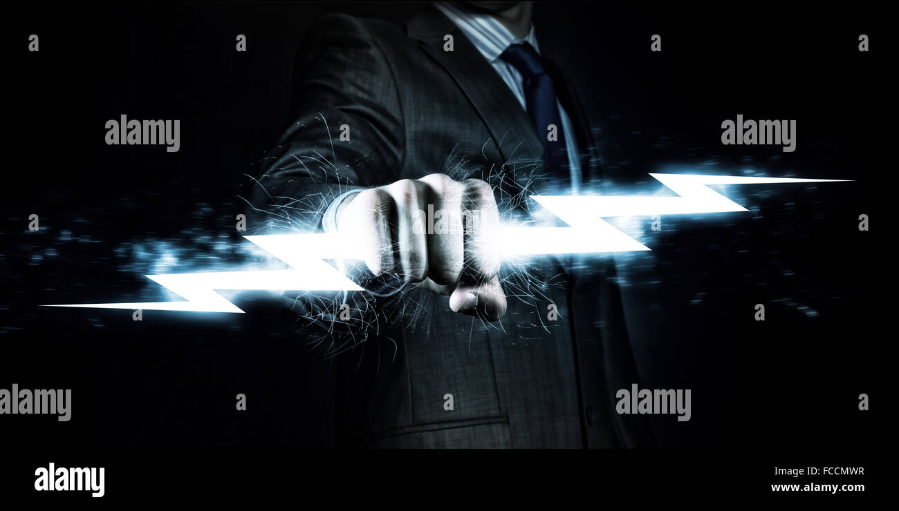 Businessman holding lightning in fist. Power and control Stock Photo ...