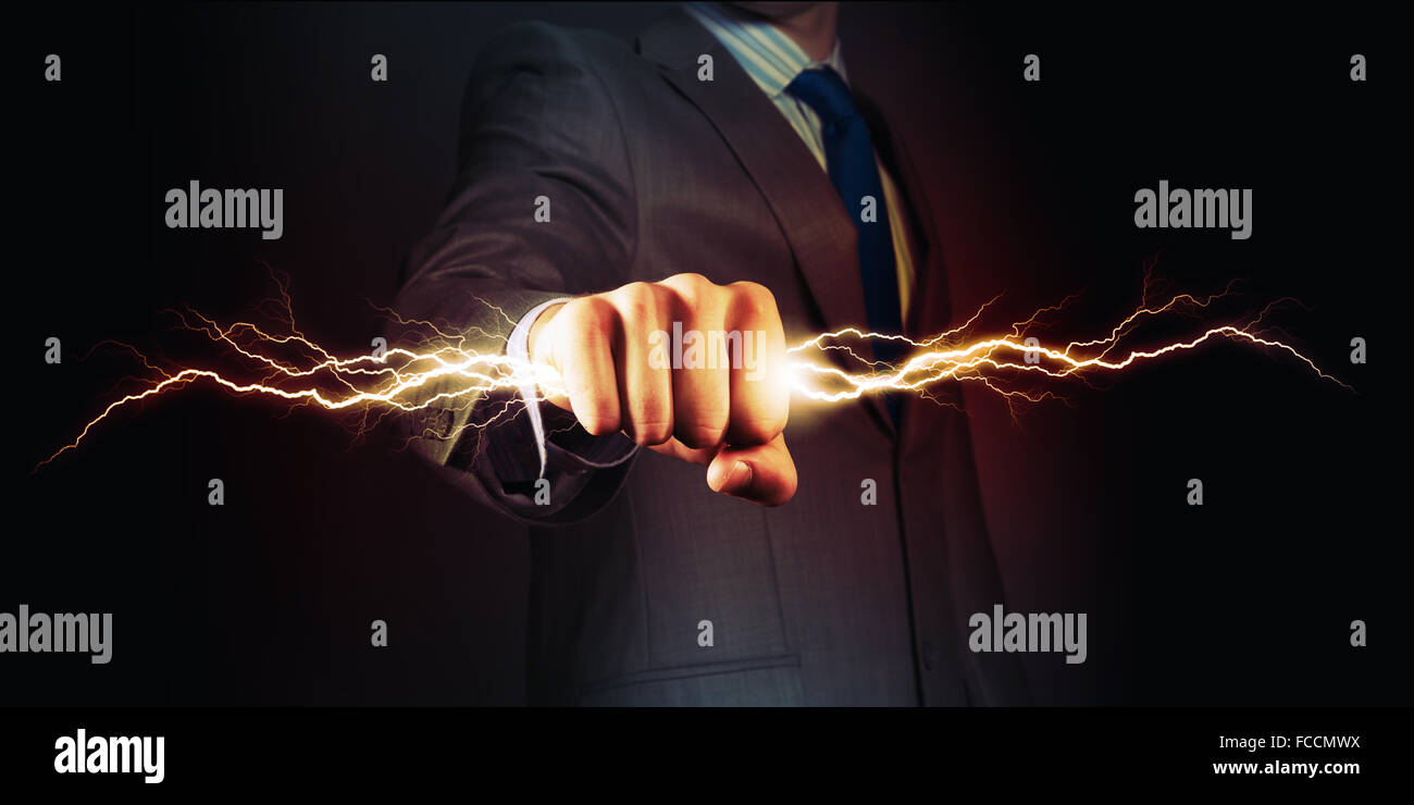 Businessman holding lightning in fist. Power and control Stock Photo ...