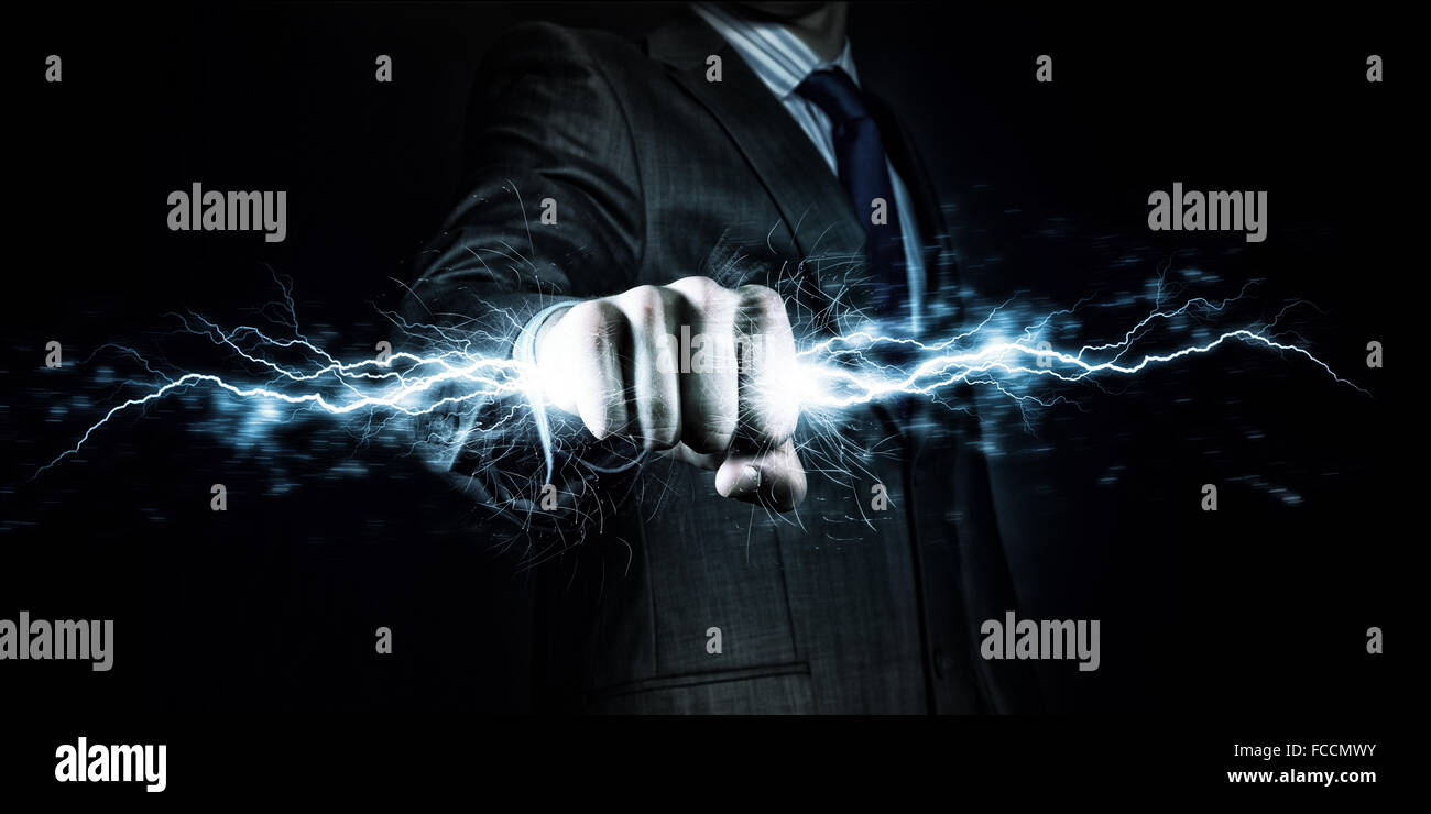 Businessman holding lightning in fist hi-res stock photography and ...