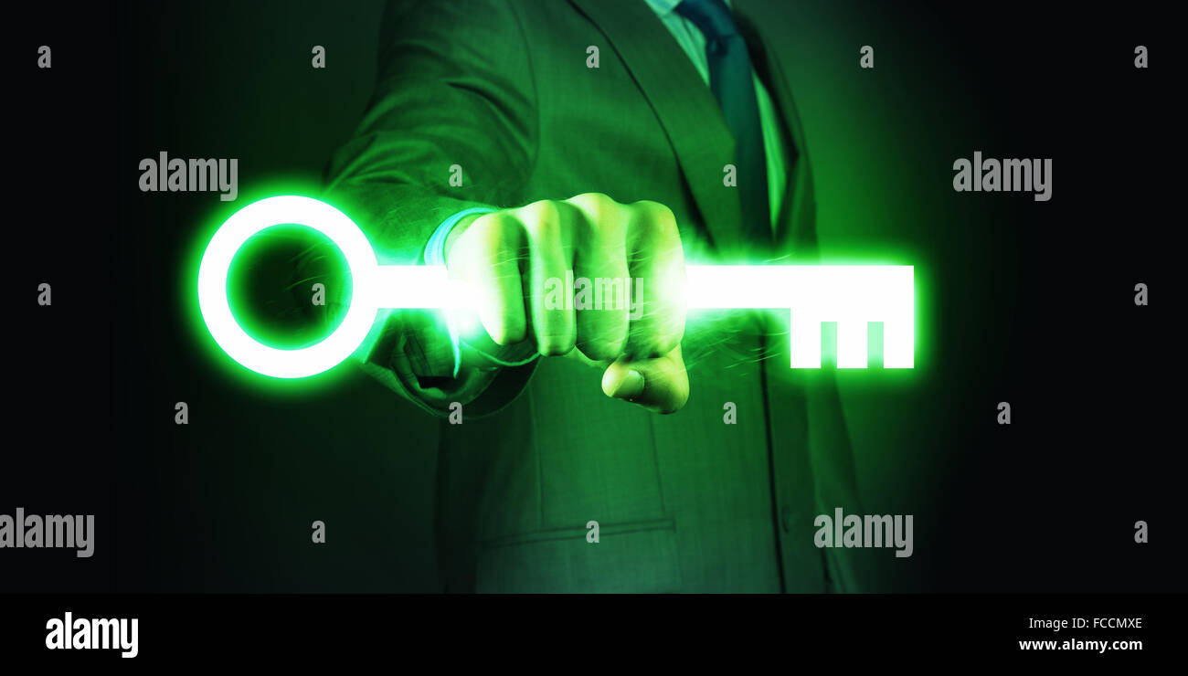 Powerful businessman holding key in his fist Stock Photo - Alamy