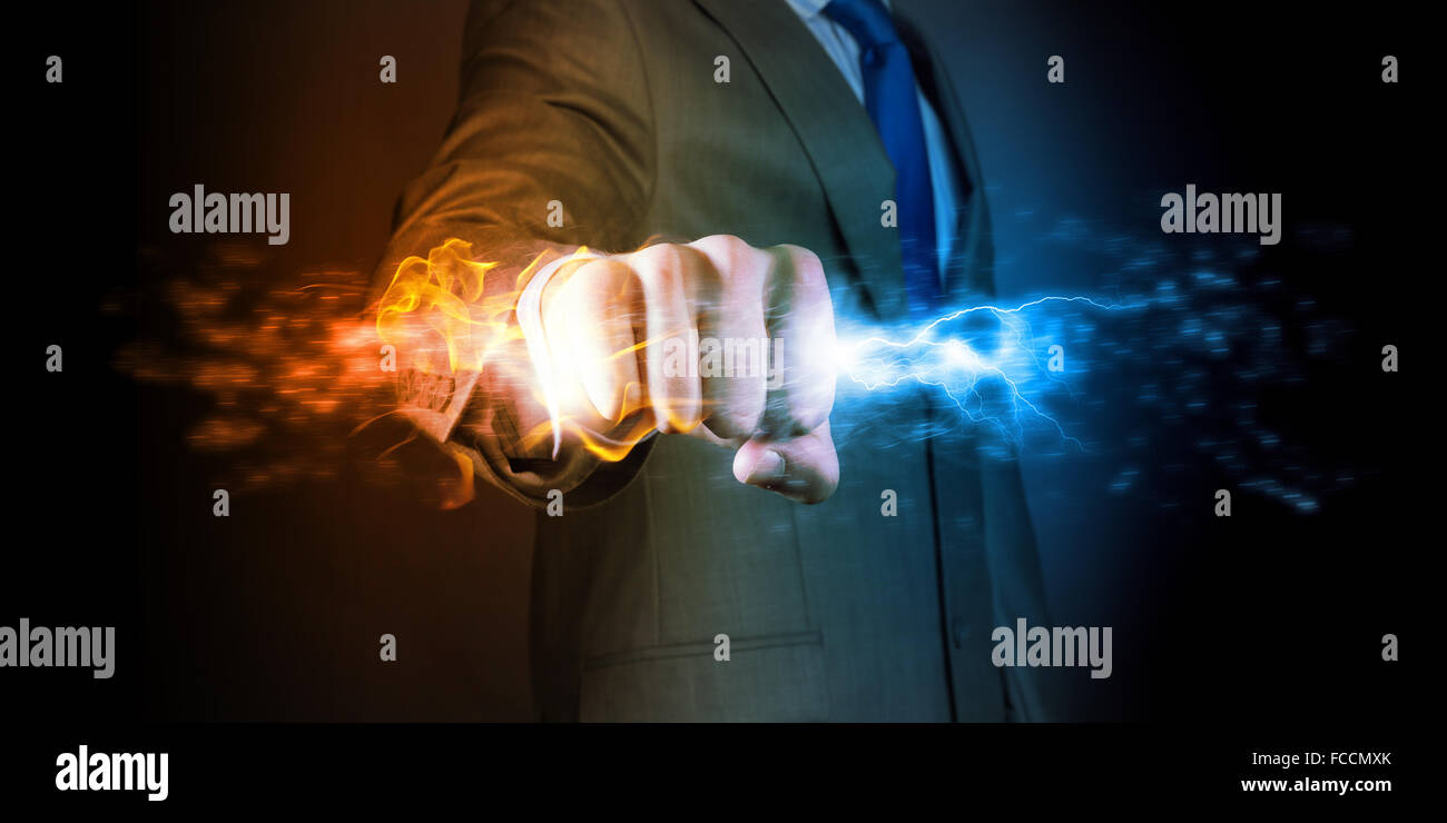 Businessman holding fire flames in fist. Power and control Stock Photo ...