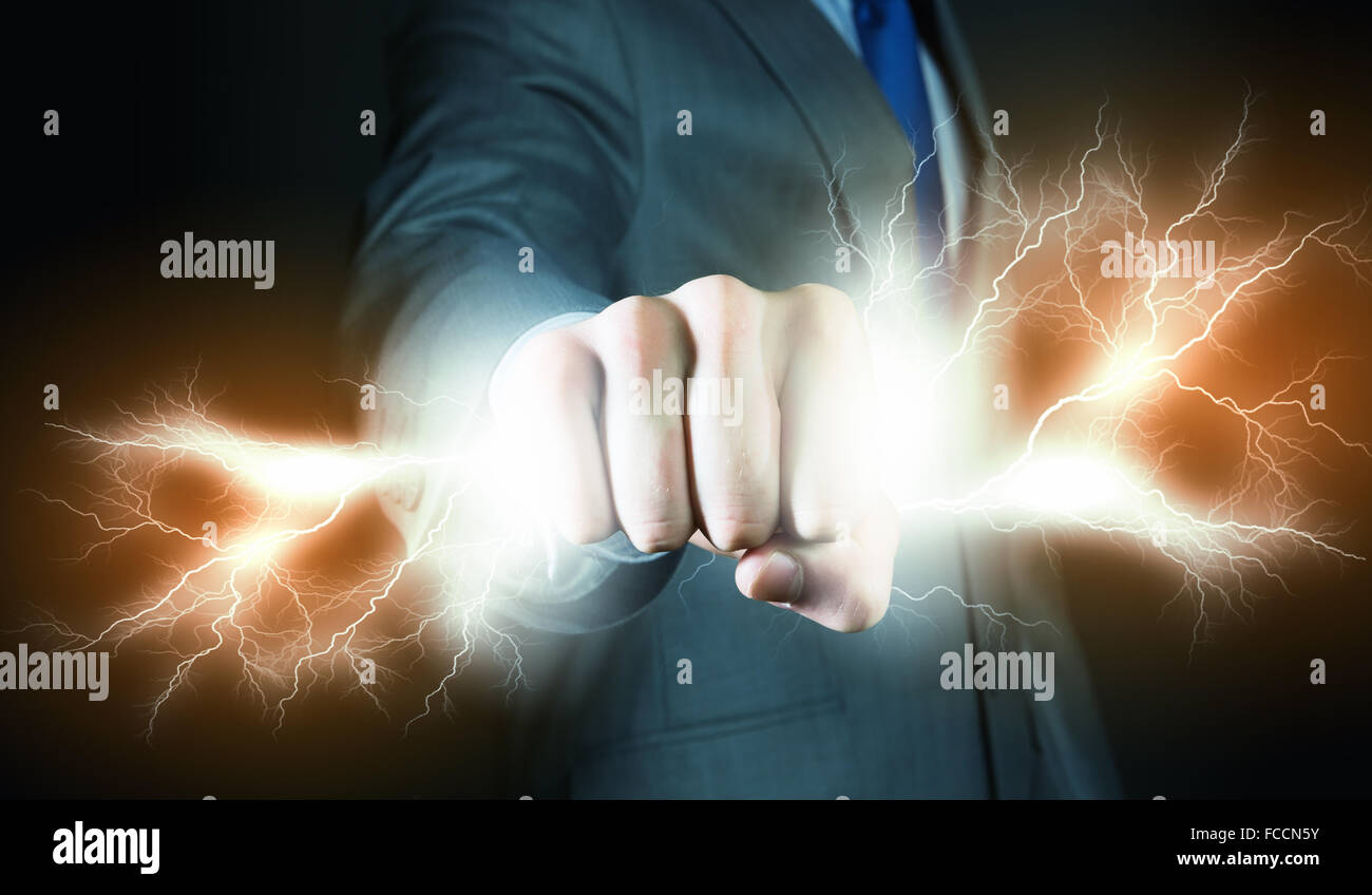 Businessman holding lightning in fist hi-res stock photography and ...