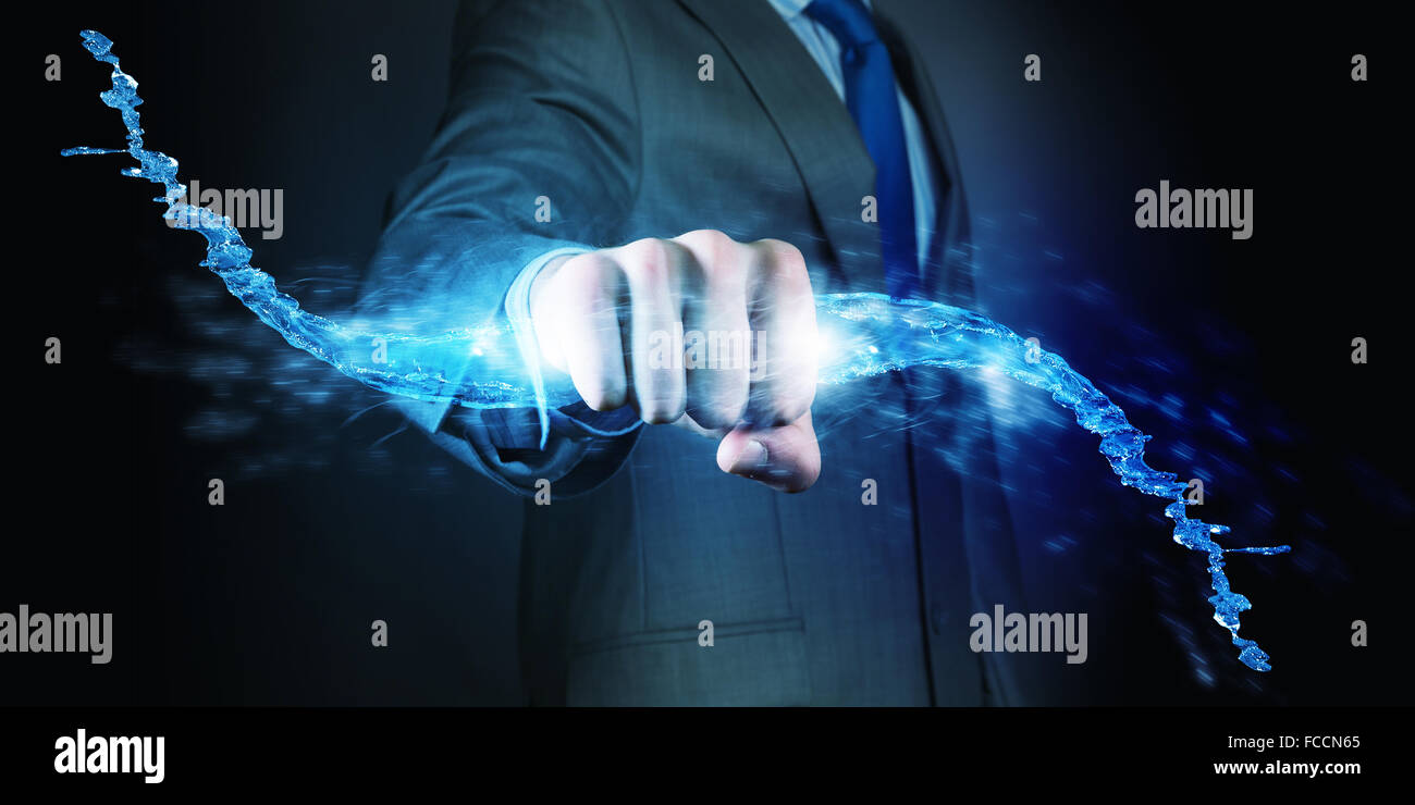 Businessman holding water splash in fist. Power and control Stock Photo ...