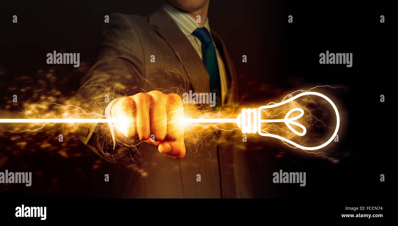 Businessman holding lightning in fist. Power and control Stock Photo ...