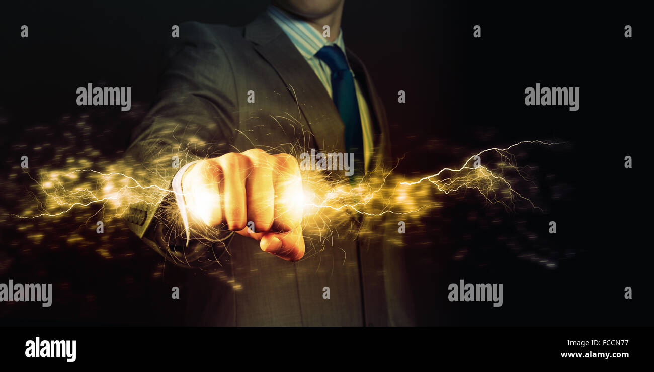 Businessman holding lightning in fist. Power and control Stock Photo ...