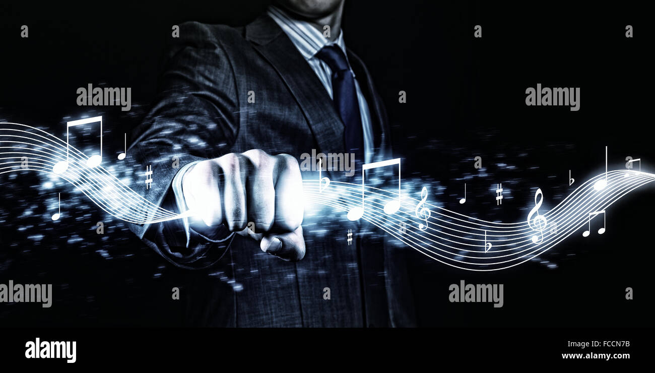 Powerful businessman holding items in his fist Stock Photo - Alamy