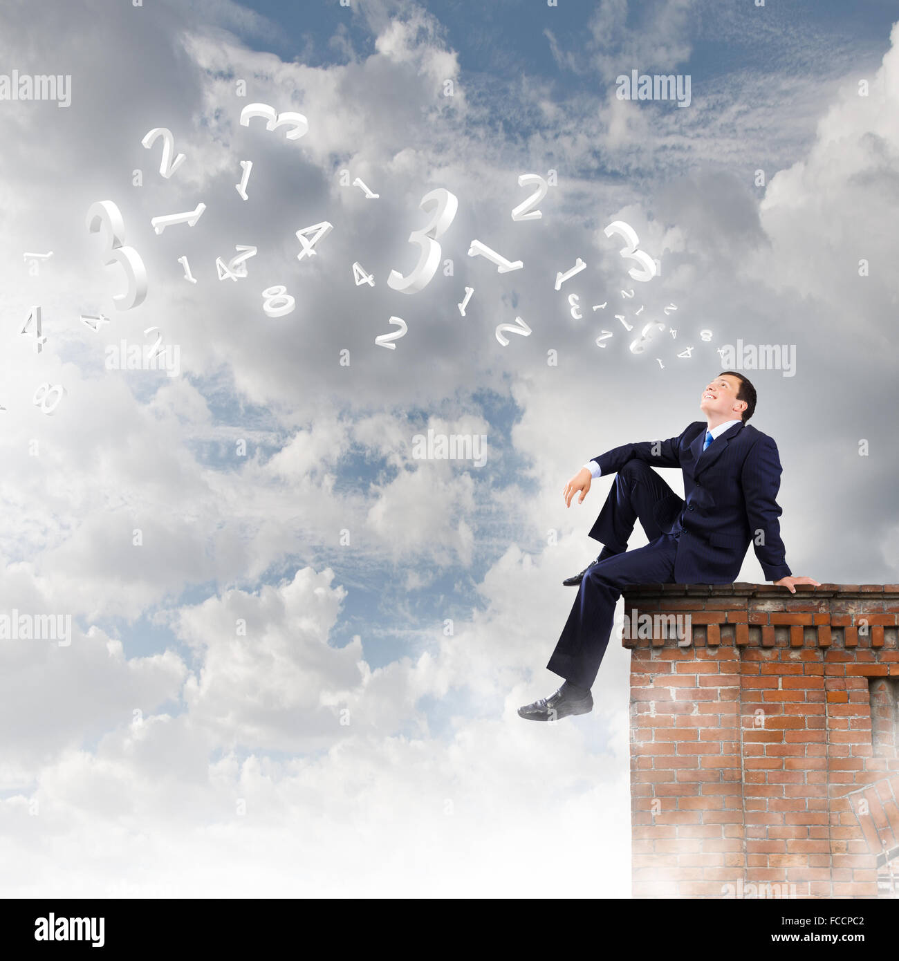 Young successful businessman sitting on top of building Stock Photo - Alamy