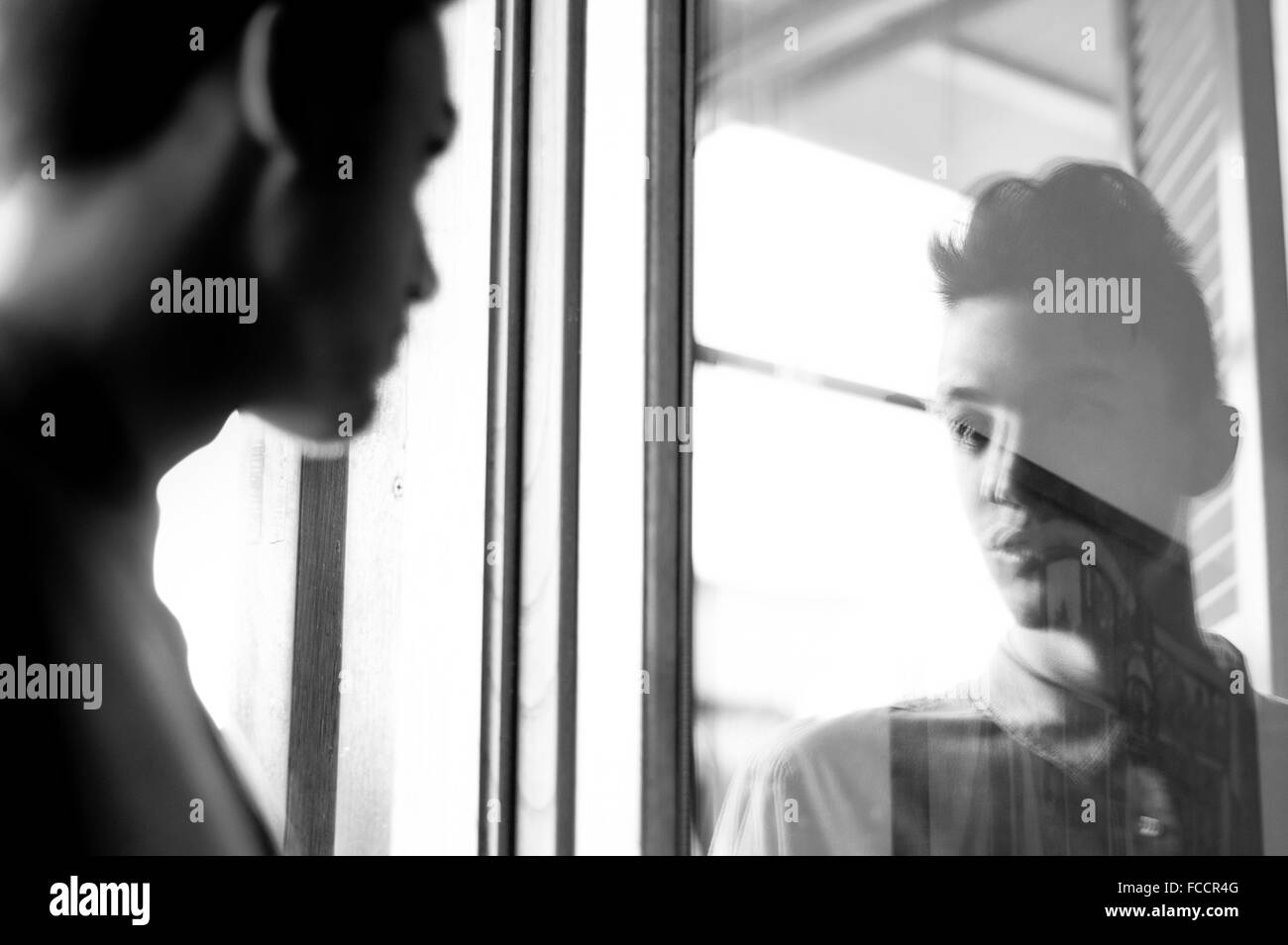 Young man reflection window Black and White Stock Photos & Images - Alamy