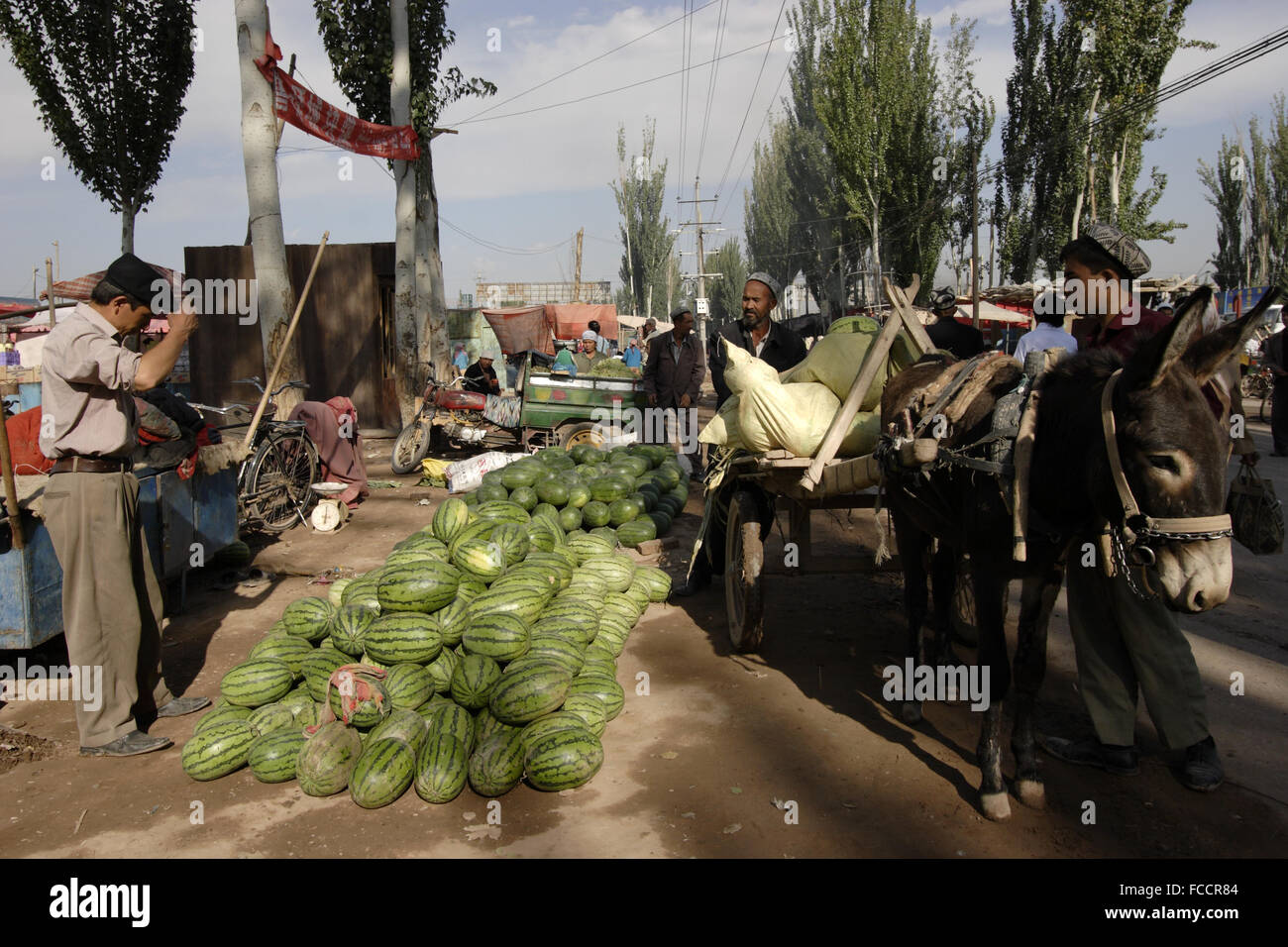 Uyghur men selling watermelons at traditional Sunday Market, Kashgar ...